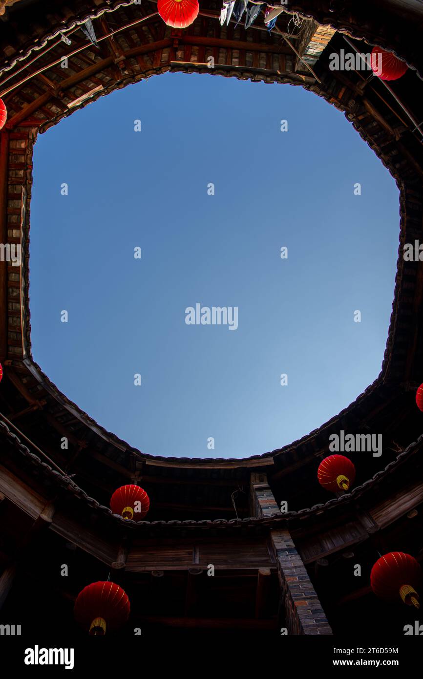 The sky above the round buildings of Hekeng Tulou Cluster in the early ...