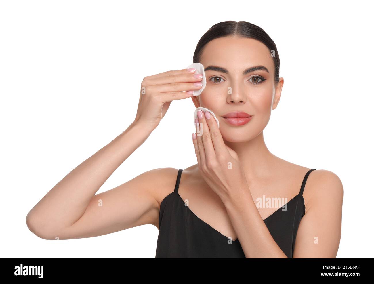 Beautiful woman removing makeup with cotton pads on white background ...