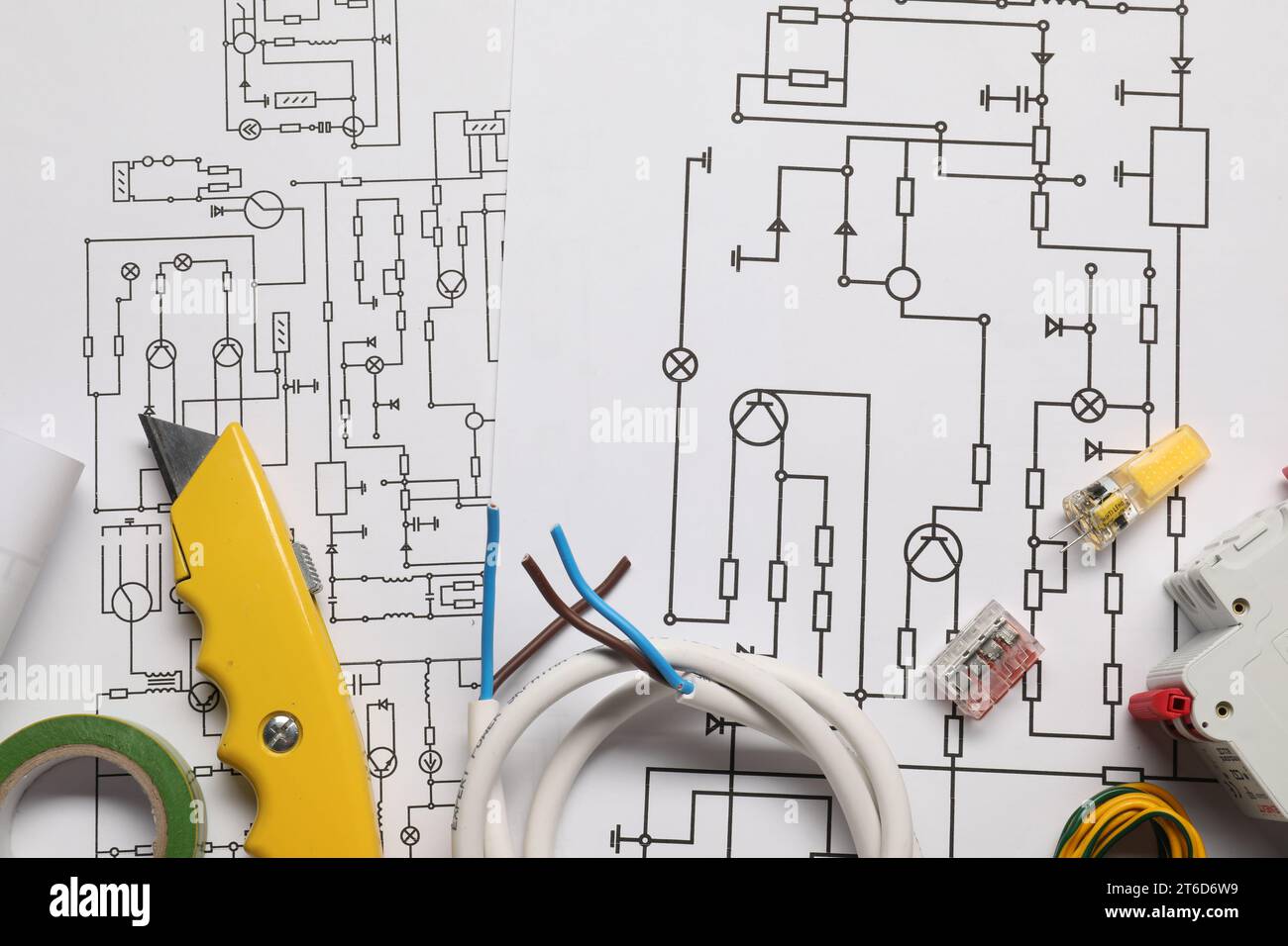 Wires, knife and other electrician's equipment on wiring diagrams, flat ...