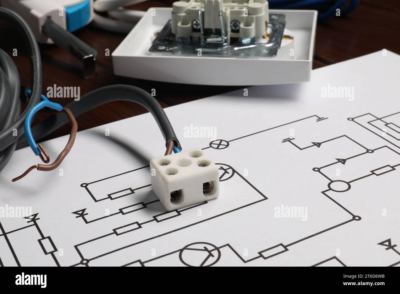 Wiring diagram, wires and disassembled light switch on wooden table ...