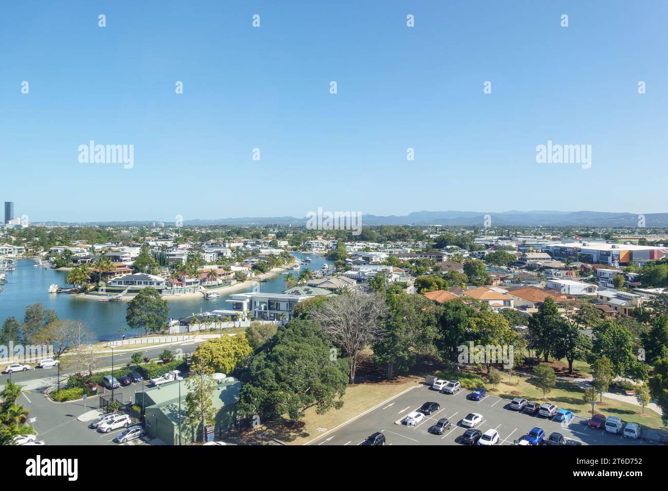 Aerial view across urban Surfers Paradise to distant hills and horizon ...