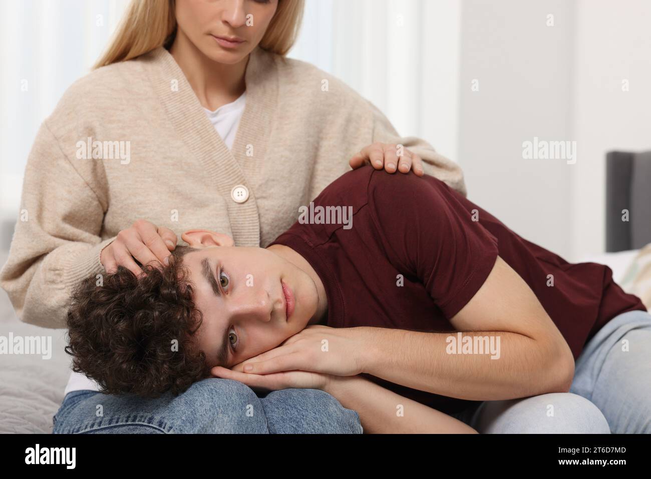Mother consoling her upset son at home. Teenager problems Stock Photo ...