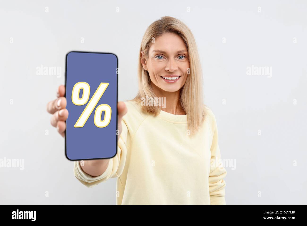 Discount, offer, sale. Woman showing mobile phone with percent sign on ...