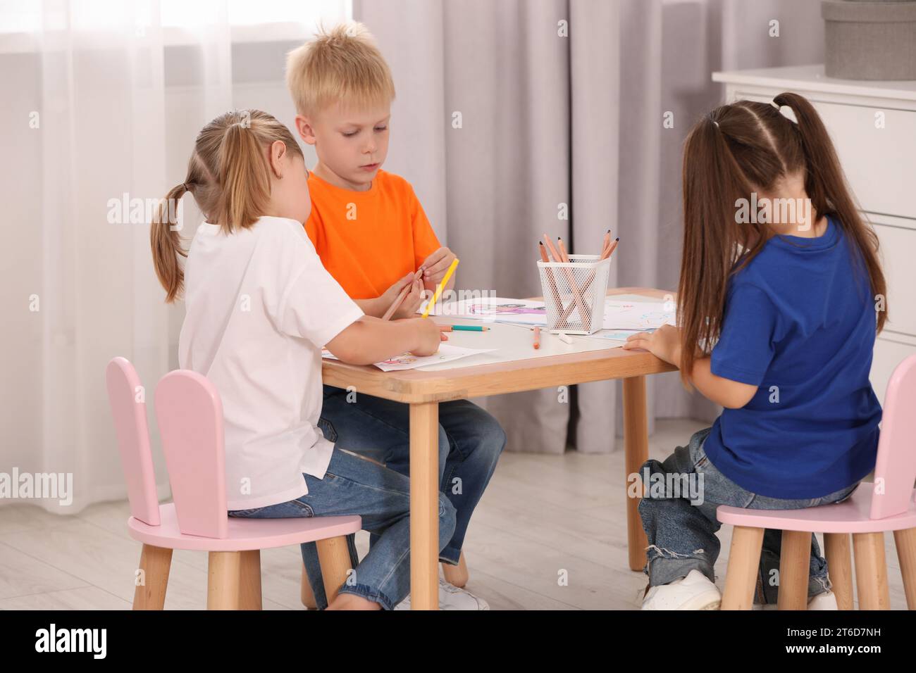 Cute little children drawing at desk in kindergarten Stock Photo - Alamy