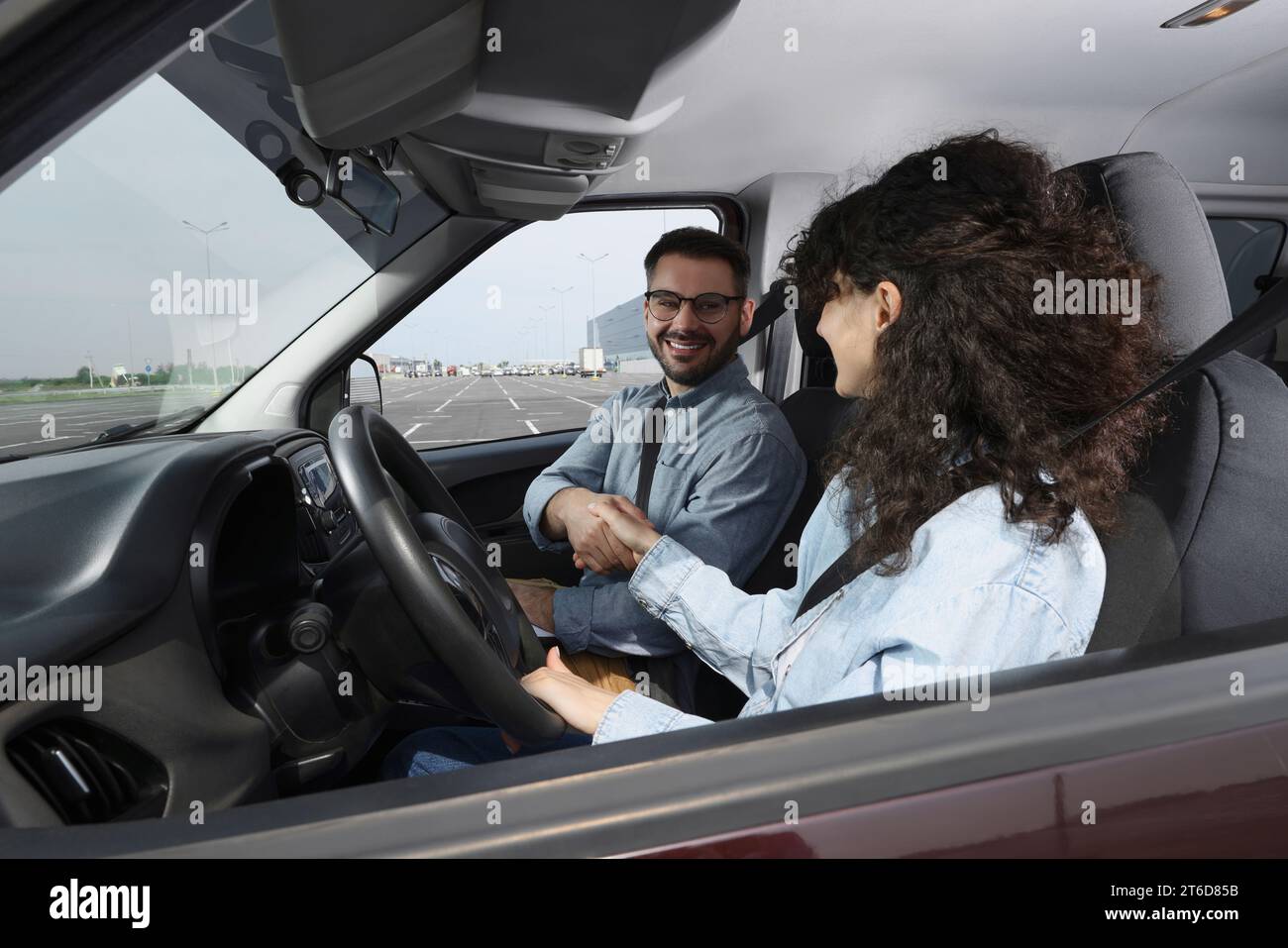 Driving school. Happy student shaking hands with driving instructor ...