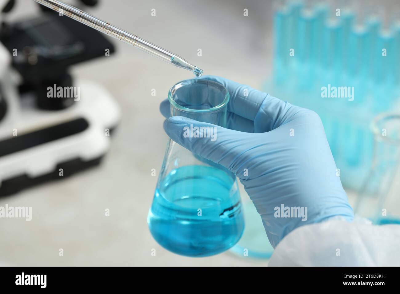 Lab assistant dripping liquid in hi-res stock photography and images ...