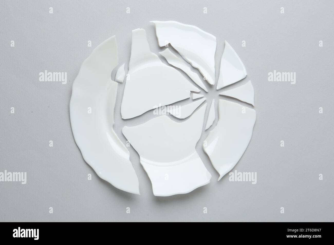 Pieces of broken ceramic plate on light grey background, flat lay Stock ...
