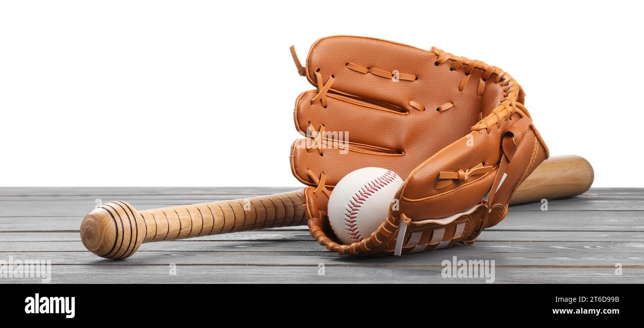 Baseball bat, ball and catcher's mitt on grey wooden table against ...