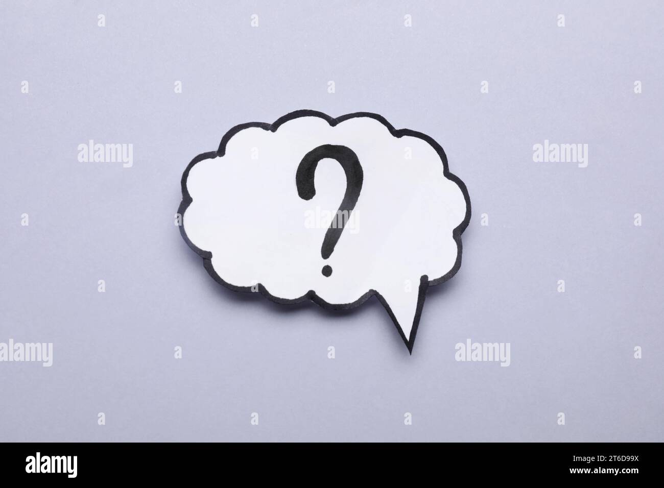 Paper speech bubble with question mark on light grey background, top ...