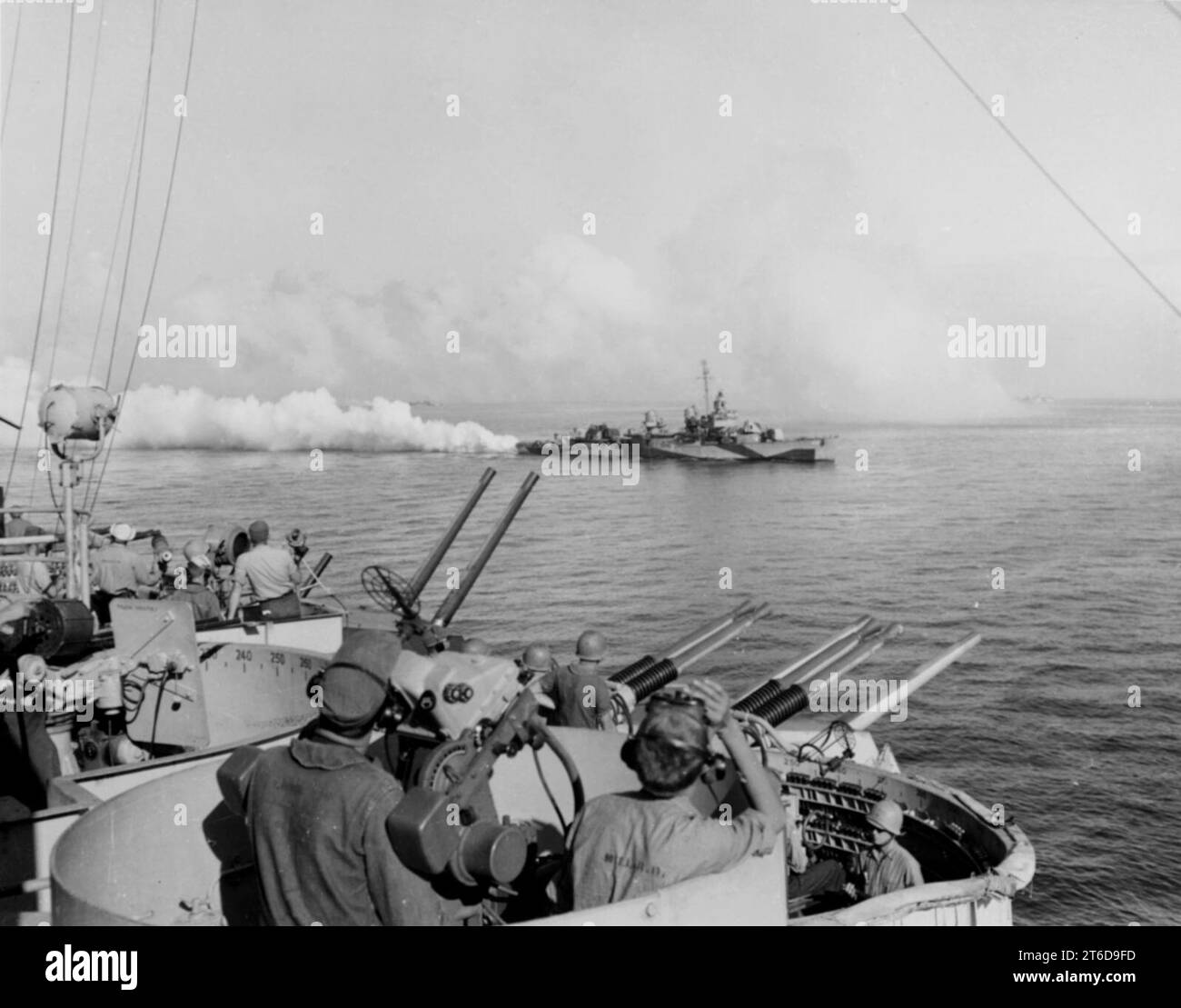 USS Cony (DD-508) lays a smoke screen off Leyte on 20 October 1944 ...