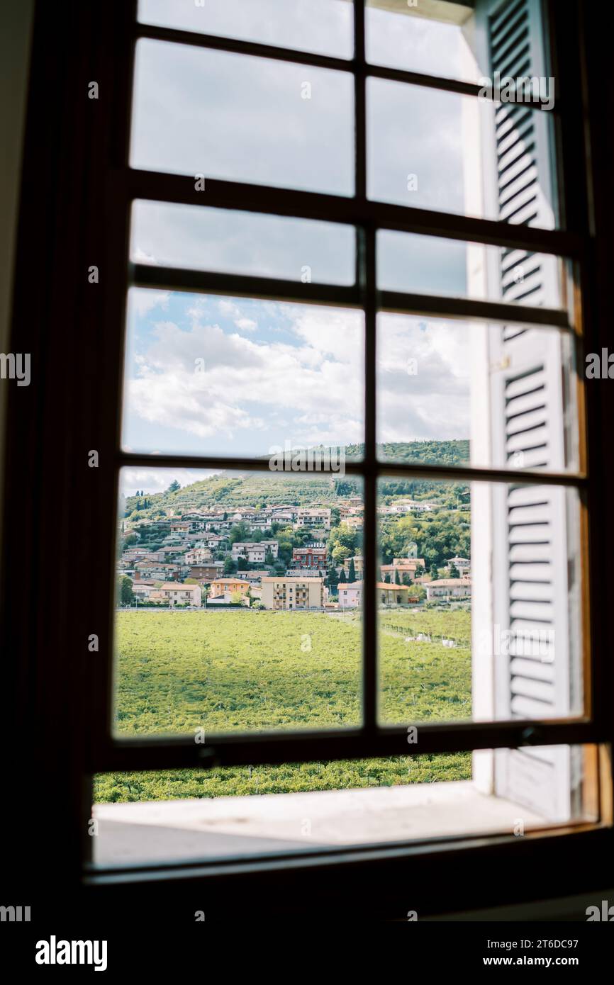 View from the window of a green lawn and ancient houses at the foot of ...