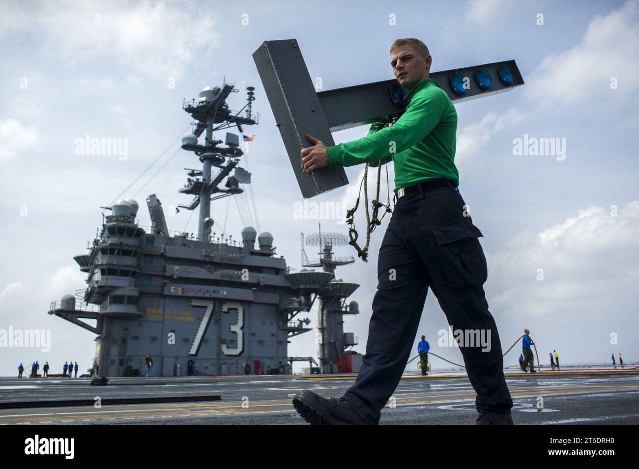 USS George Washington (CVN-73) sailor carrying visual landing aid light ...