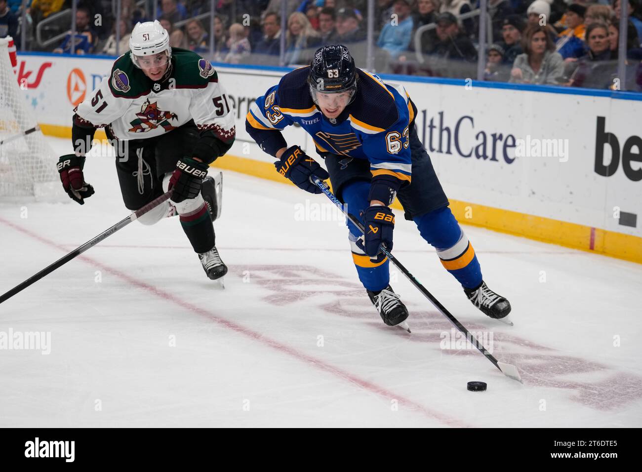 St. Louis Blues' Jake Neighbours (63) reaches for a loose puck as ...