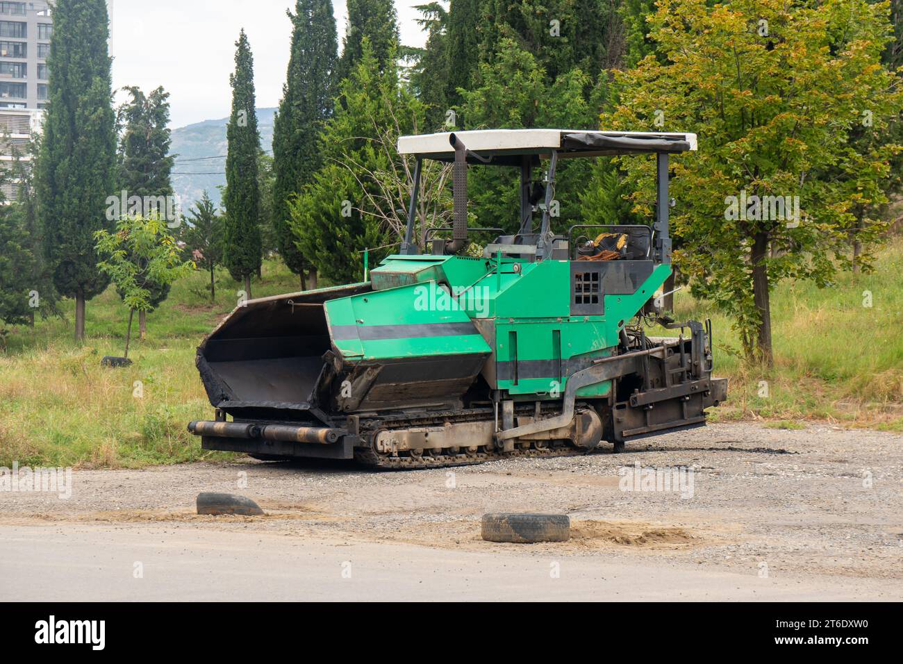 Asphalt paver machine. Asphalt finisher or paving machine placing a ...