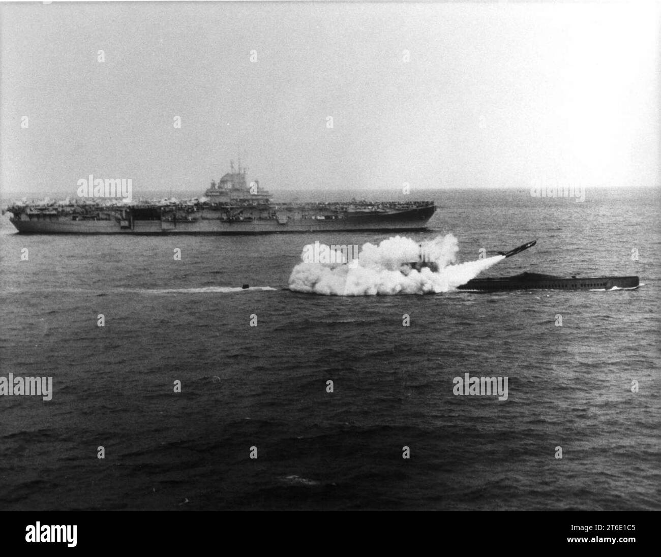 USS Halibut (SSGN-587) firing a Regulus missile next to USS Lexington ...