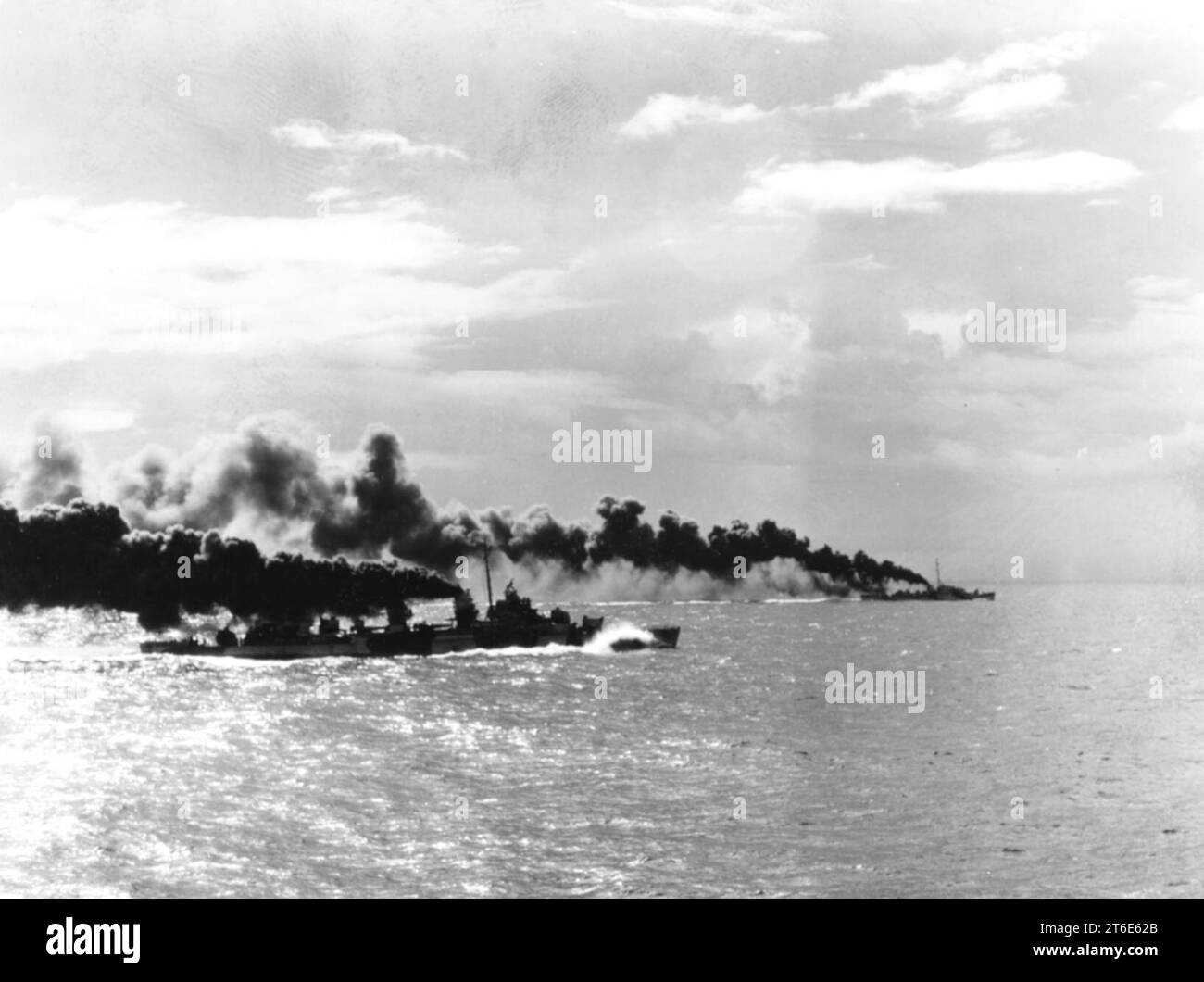 USS Heermann (DD-532) and USS John C. Butler (DE-339) lay a smoke ...