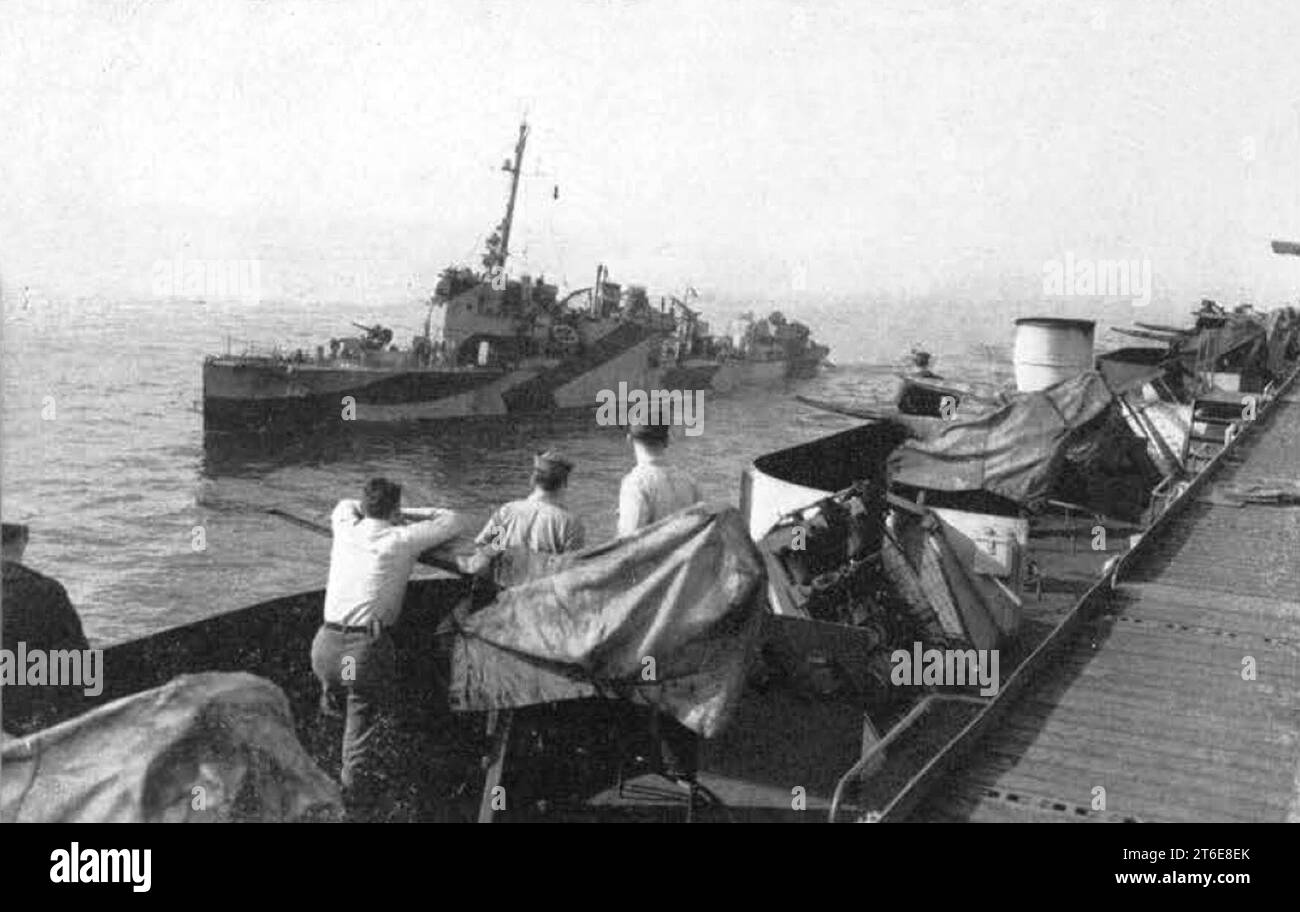 USS Hulbert (DD-342) alongside of USS Takanis Bay (CVE-89), circa in ...
