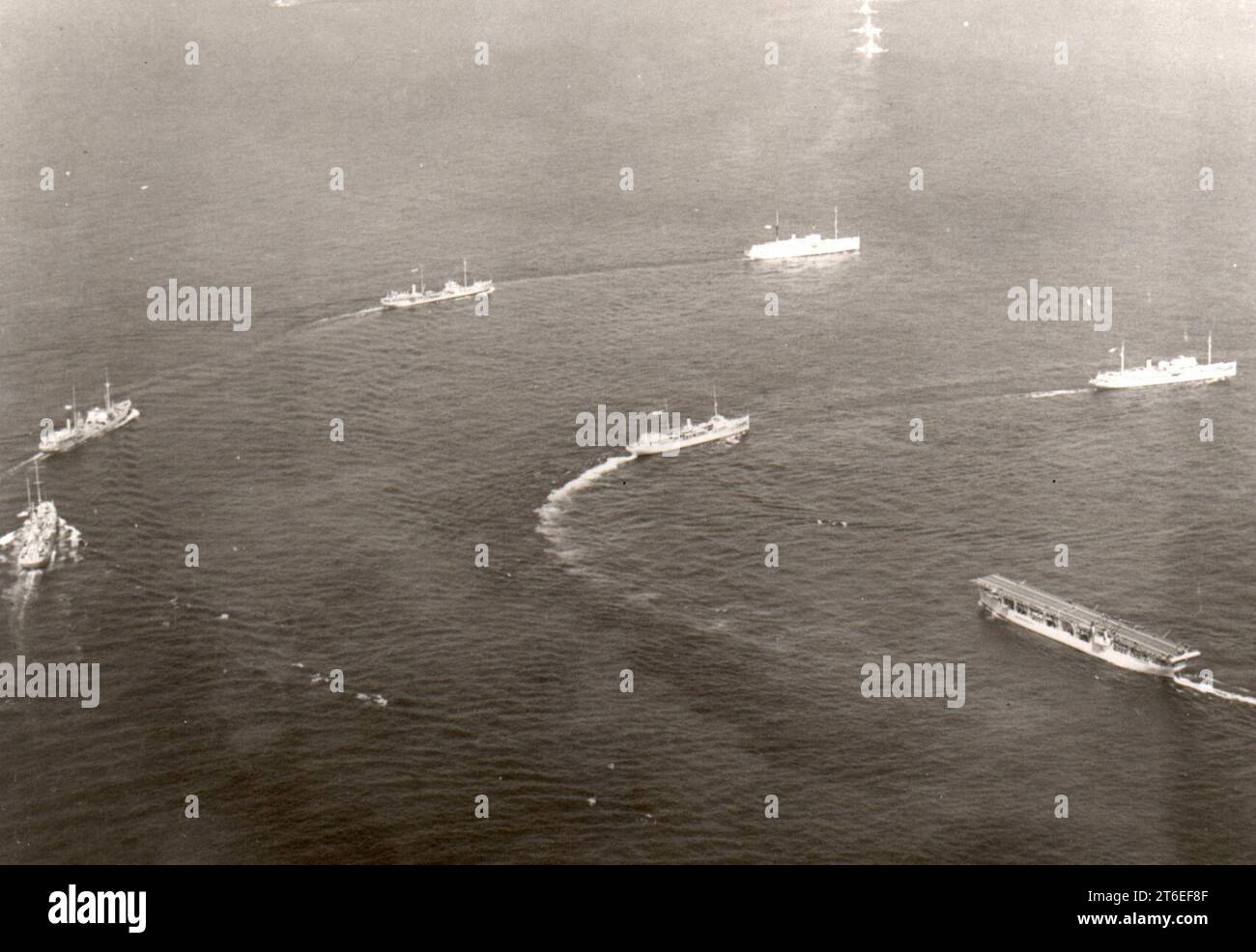 USS Langley (CV-1) underway with auxiliary ships during fleet exercises ...