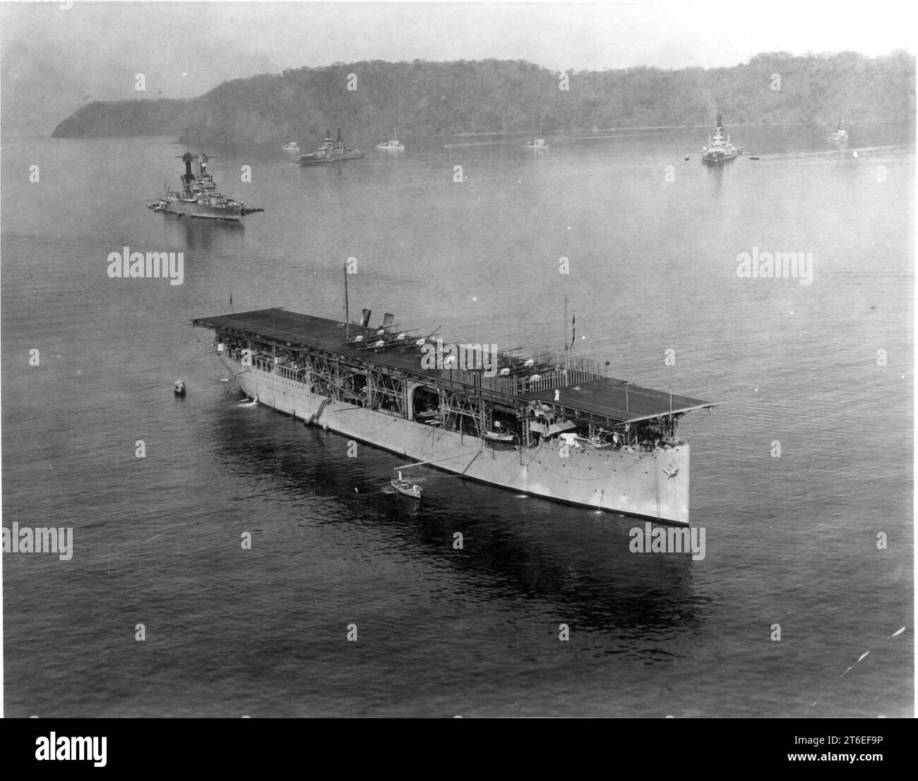 USS Langley (CV-1) at anchor with battleships, in 1923 (NNAM.1996.488 ...