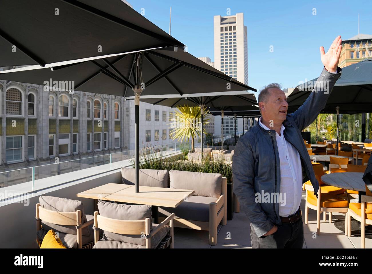 Founder Kurt Zdesar points to the surrounding view from the rooftop ...
