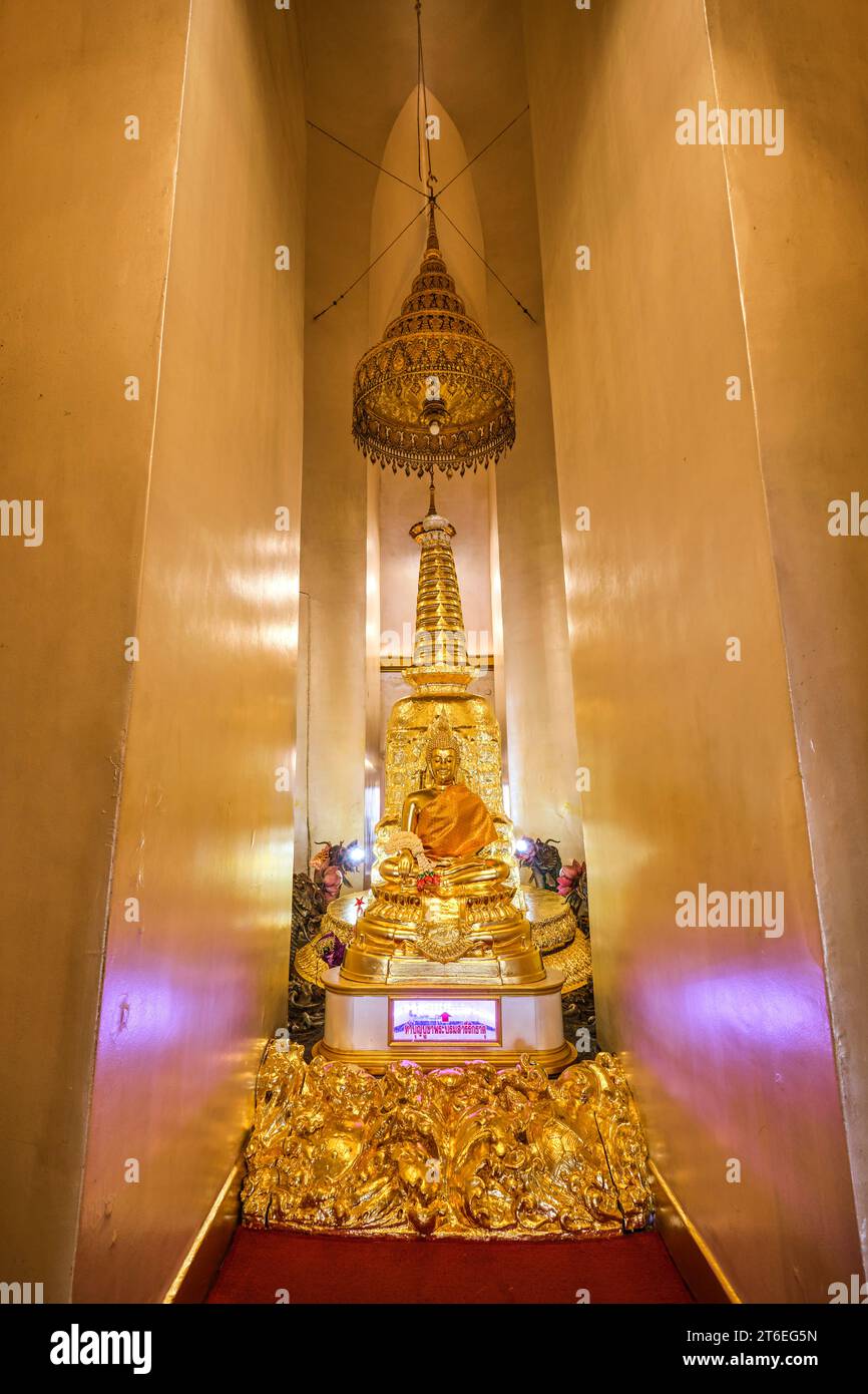 Inside, underneath the dome, a rich, fancy, gold altar of a sitting ...