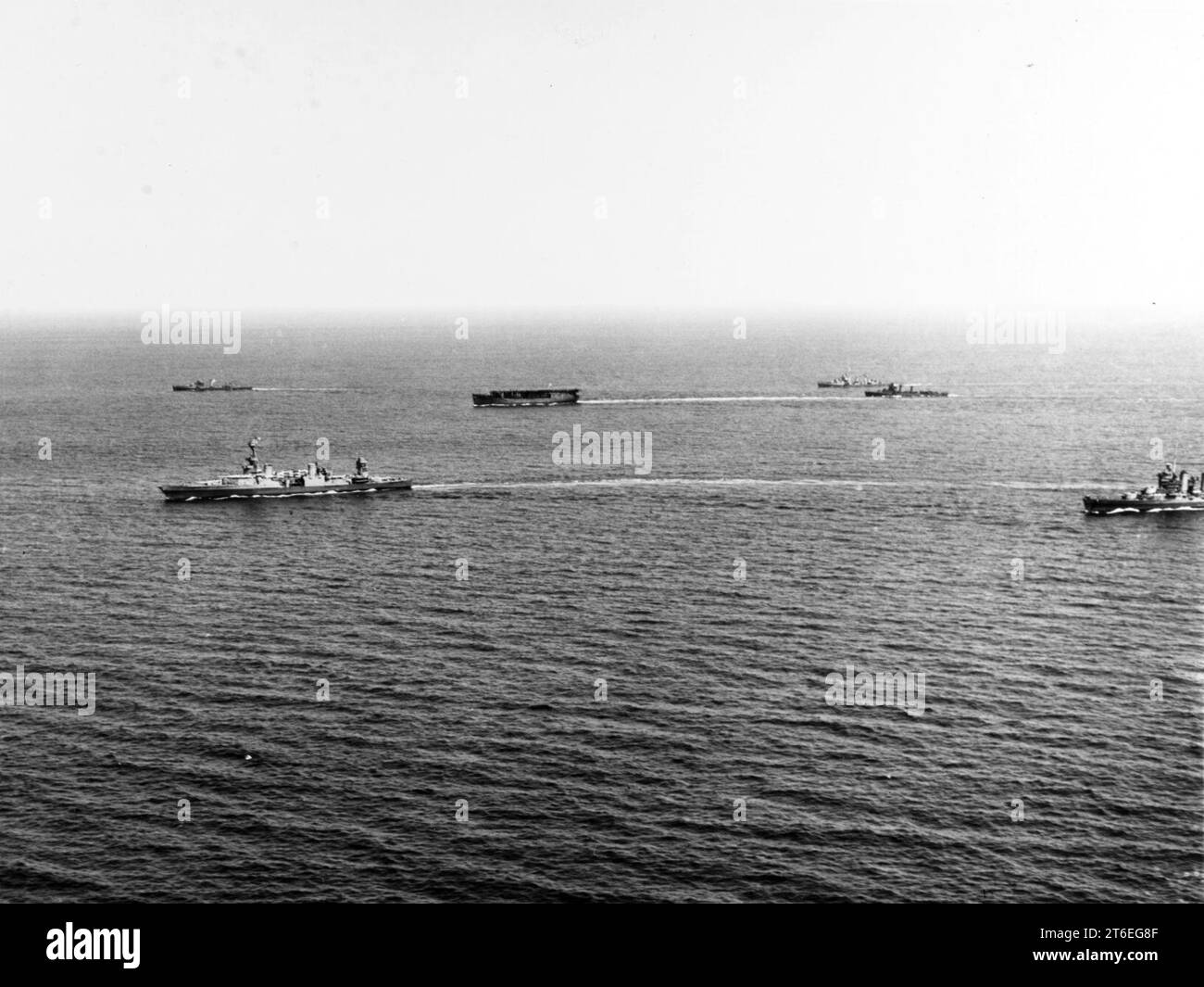 USS Long Island (AVG-1) underway with cruisers and destroyers, in ...