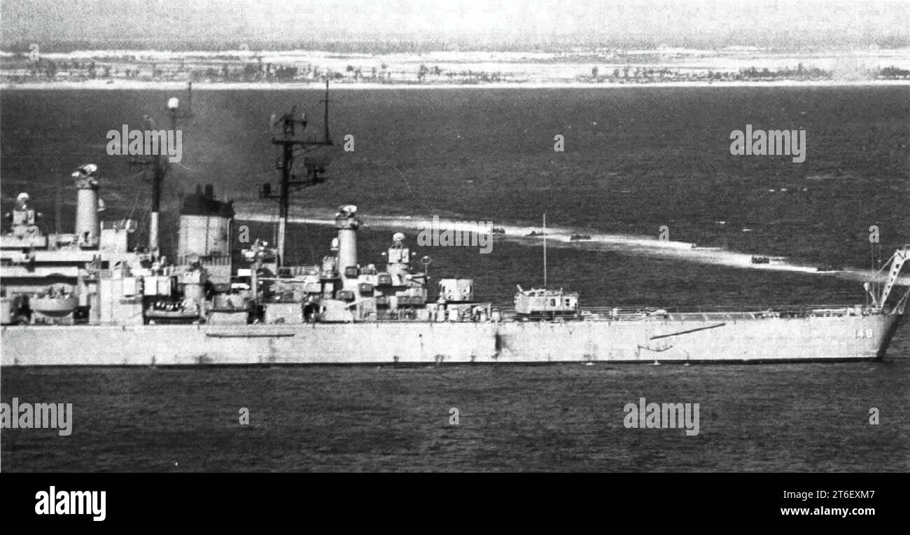 USS Newport News (CA-148) firing on North Vietnamese positions, circa ...