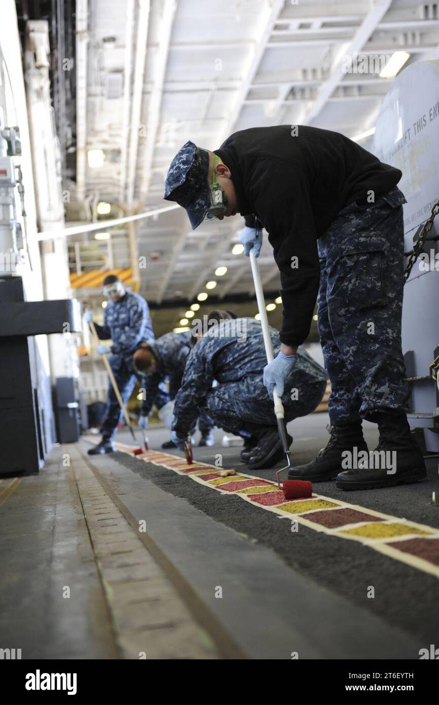 USS Nimitz sailors touch-up the hangar bay 120319 Stock Photo - Alamy