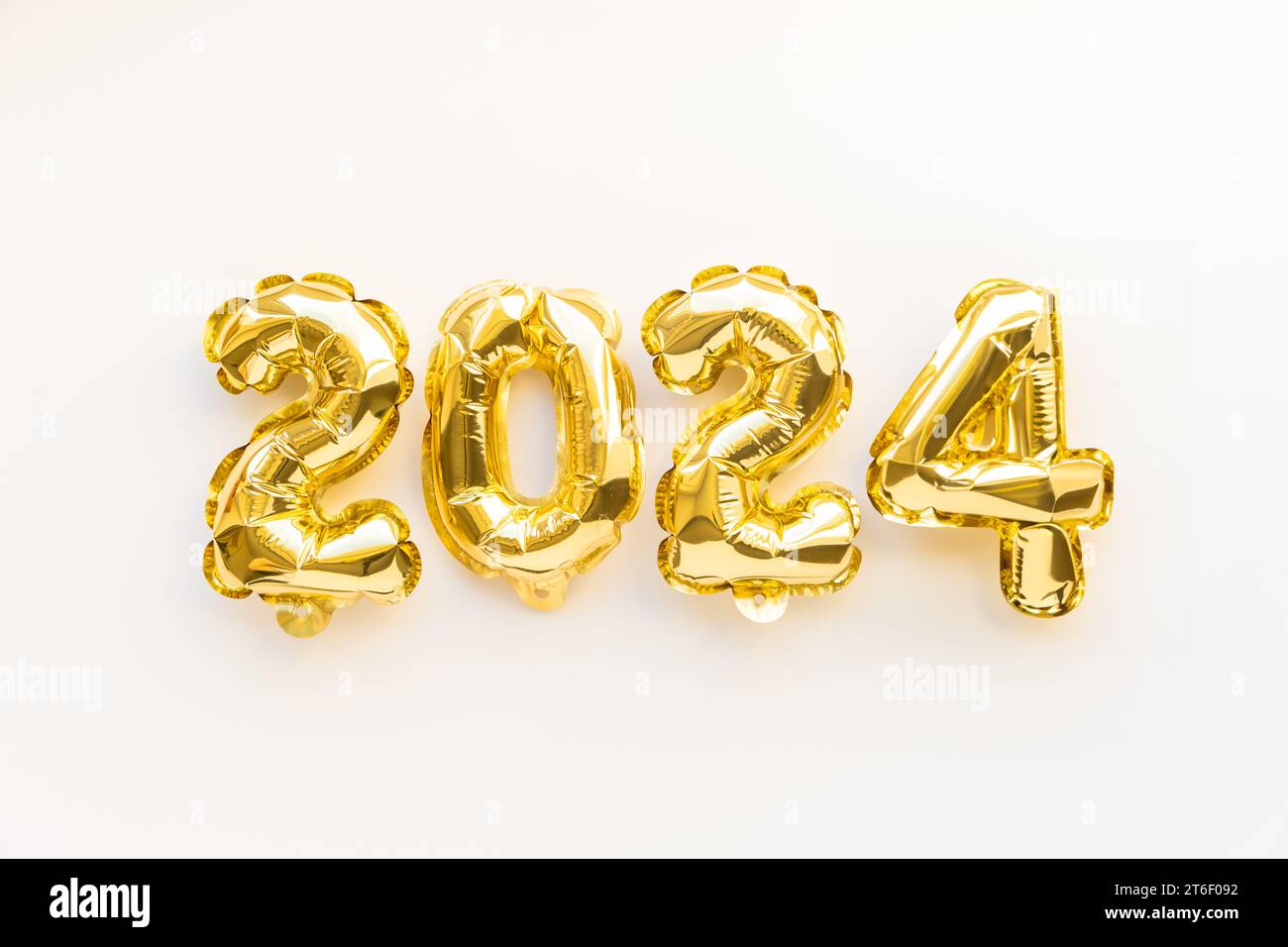 Golden foil balloons in form of numbers 2024 on white, New year card ...