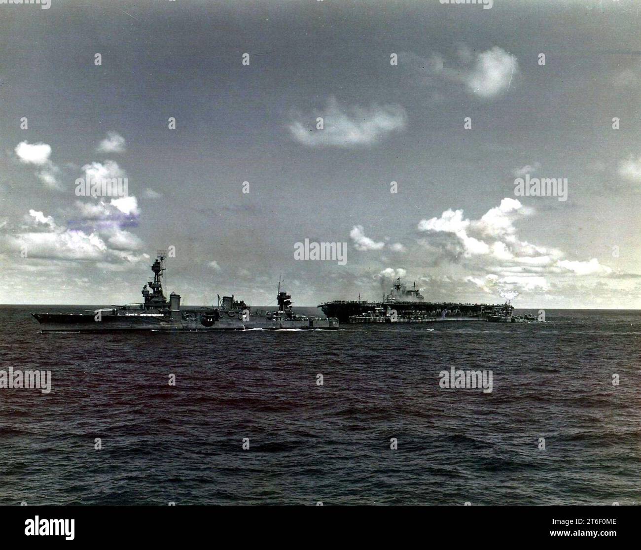 USS Northampton (CA-26) underway near listing USS Hornet (CV-8) on 26 ...