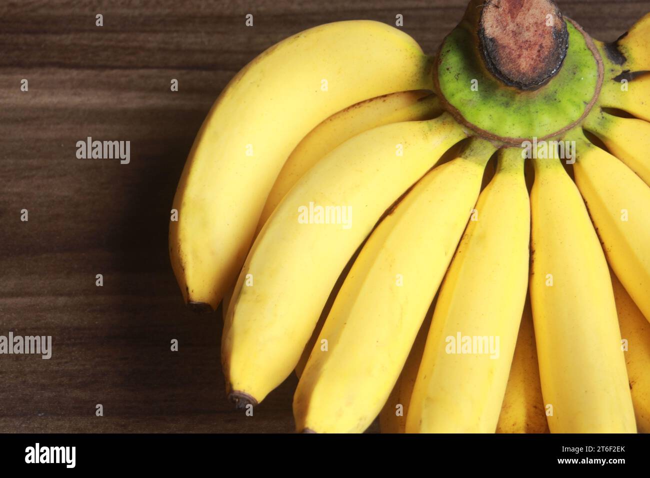 Banana fruit with wooden table on blurred background Stock Photo - Alamy