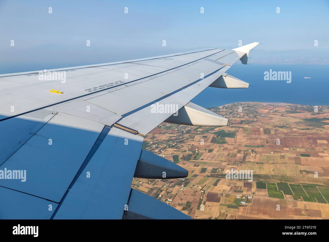 Greek island land and blue Aegean sea water aerial view out of airplane ...