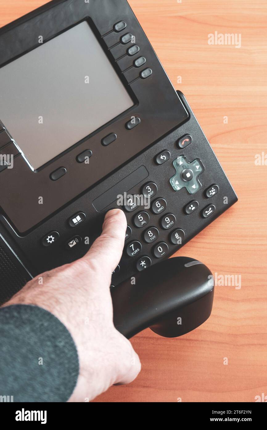 The hand holds a phone tube. Close-up. Dialing a number with your hand ...