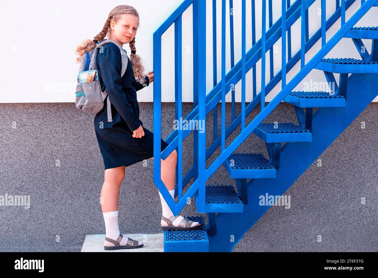 Schoolgirl climbs the stairs. Concept school days, start date, next ...