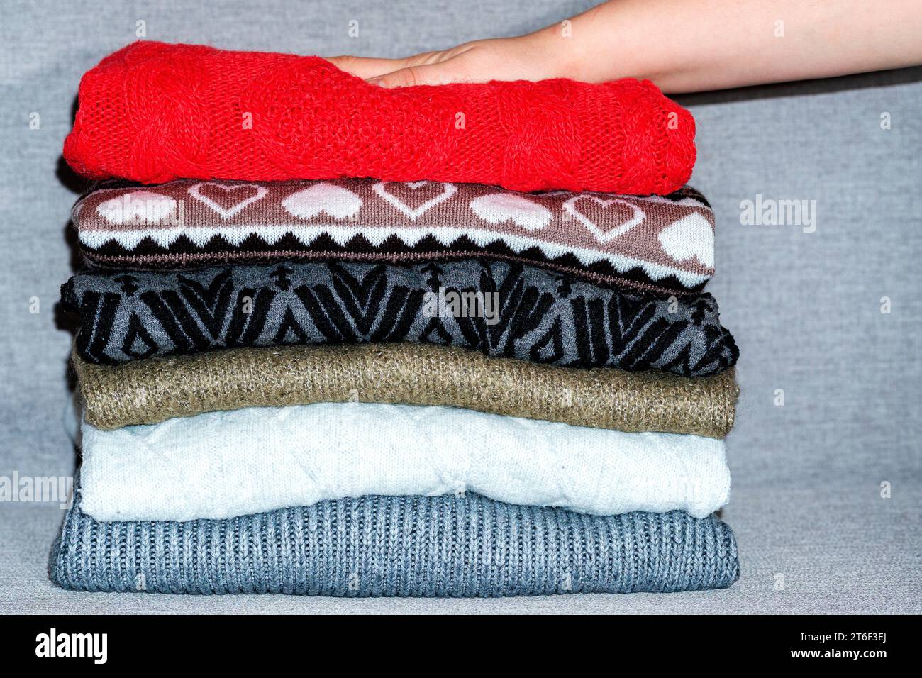 A stack of sweaters, jumpers. A Bunch of colored, woolen jumpers ...