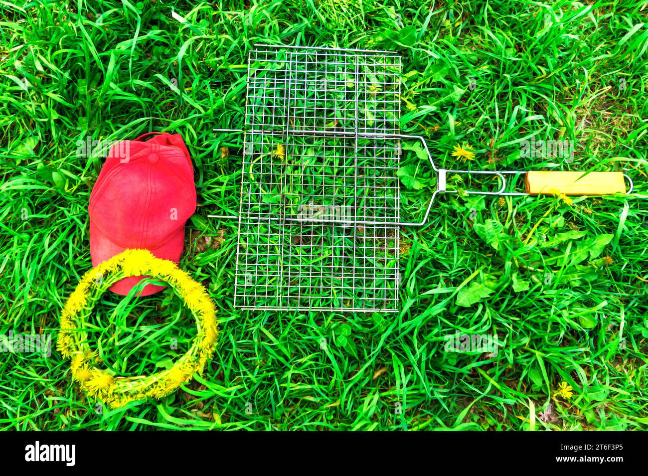 picnic items. Outdoor recreation. A cap and a wreath on a grass Stock ...