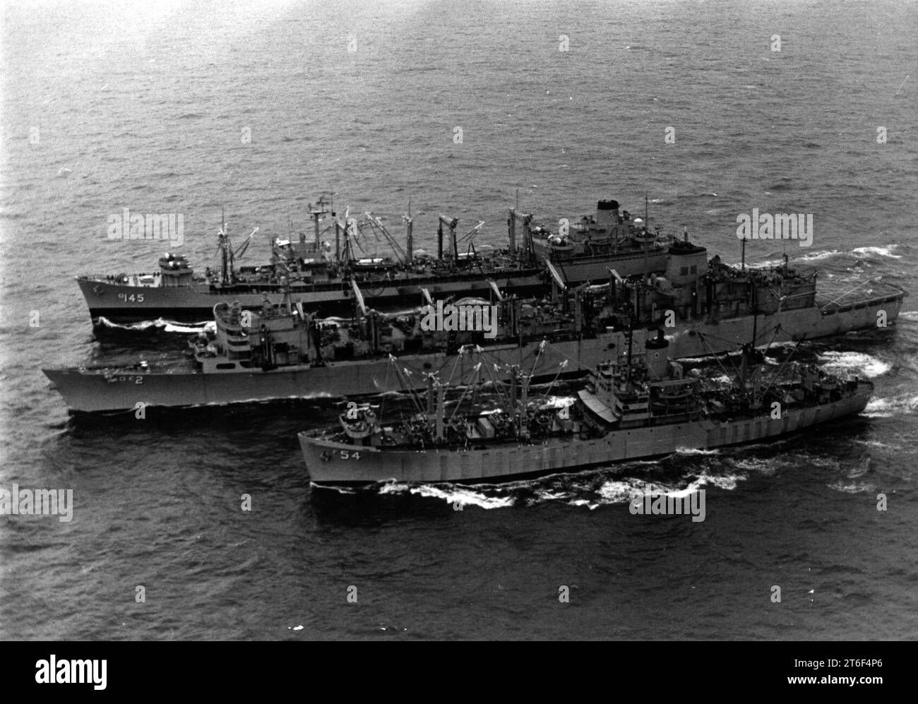 USS Pictor (AF-54) and USS Hassayampa (AO-145) replenish USS Camden ...