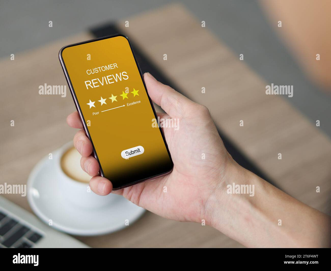 Closeup hand holding a smartphone. The phone's screen shows a five star ...