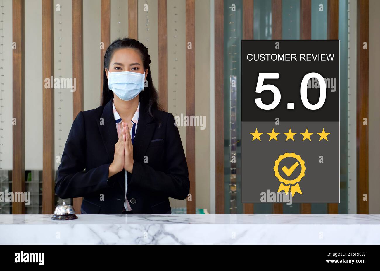 Hotel receptionist raise her hand to pay respect in thai culture, shows ...