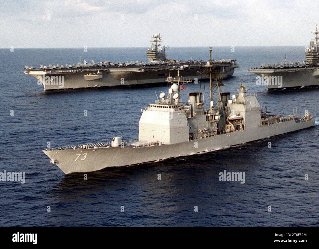 USS Port Royal (CG-73) steams alongside of USS Nimitz (CVN-68) and USS ...