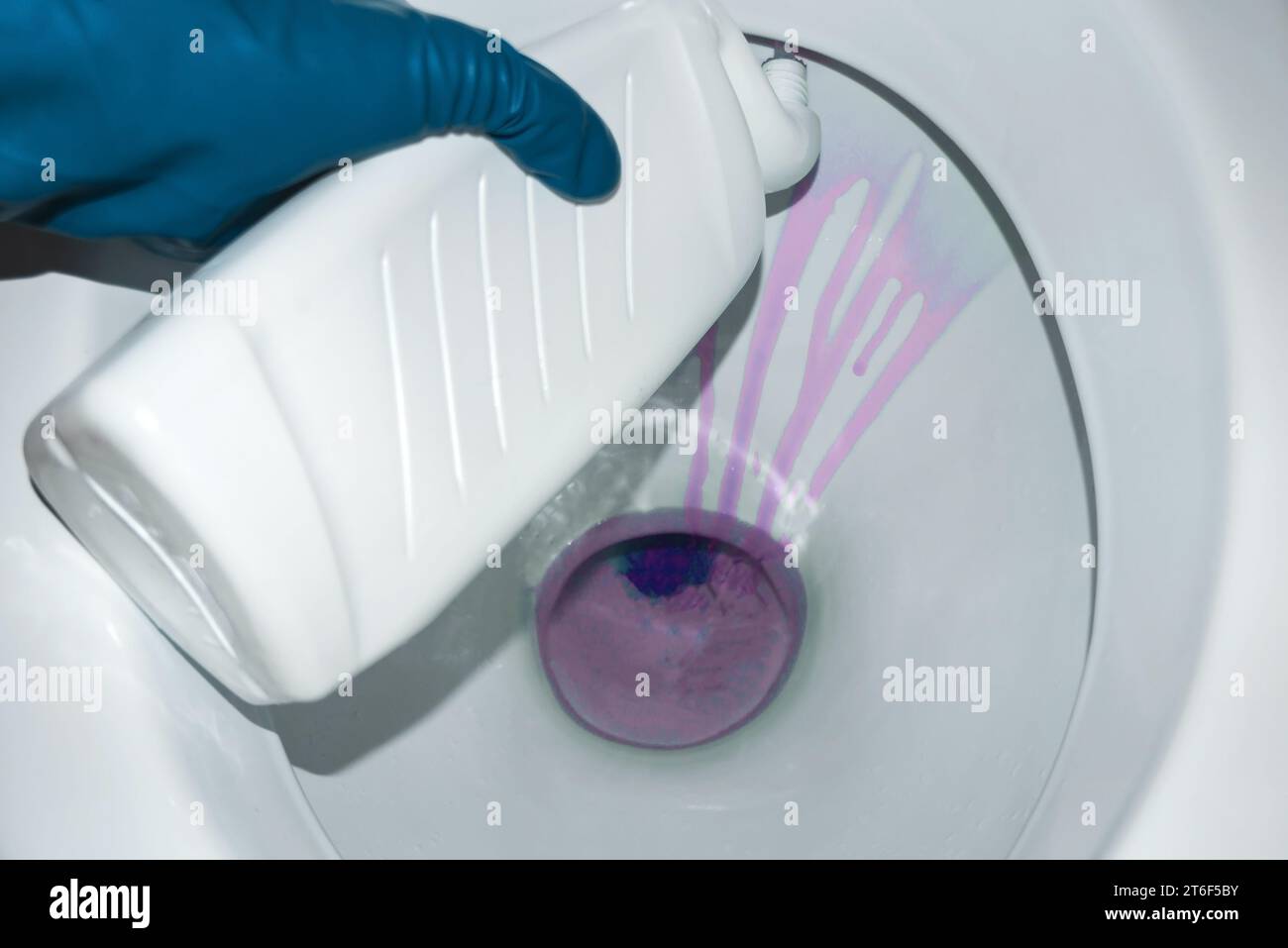 Process toilet disinfectant. Close-up. Hand holds a bottle. Purity in a ...