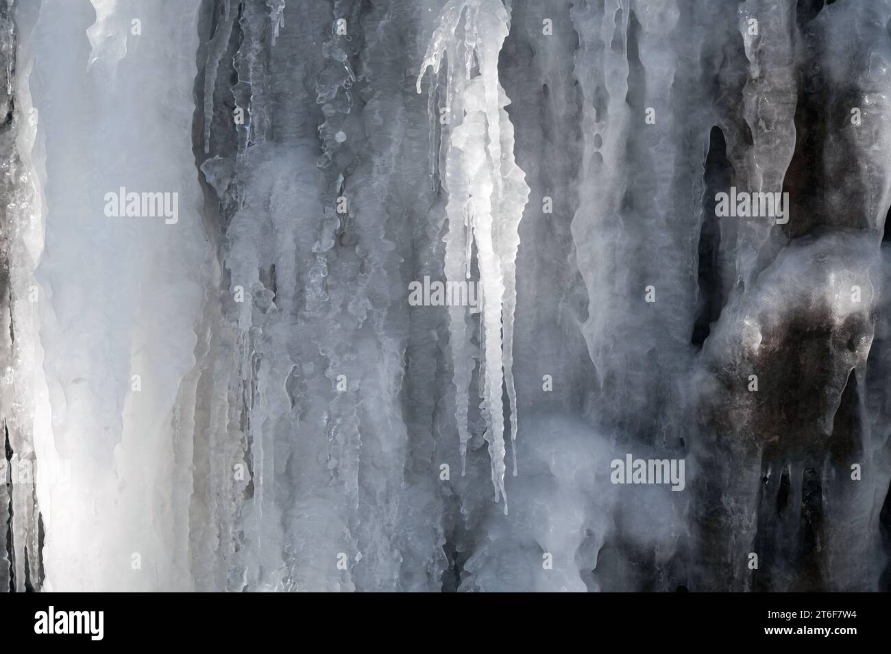 frozen icicles and icing on a stone wall in winter close-up Stock Photo ...