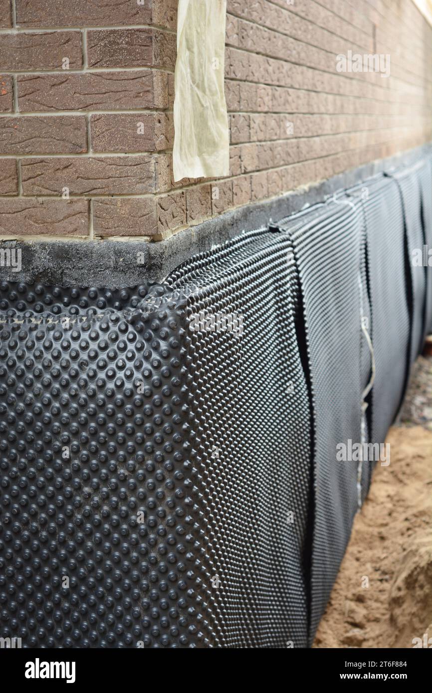 Brick house foundation wall waterproofing Stock Photo - Alamy
