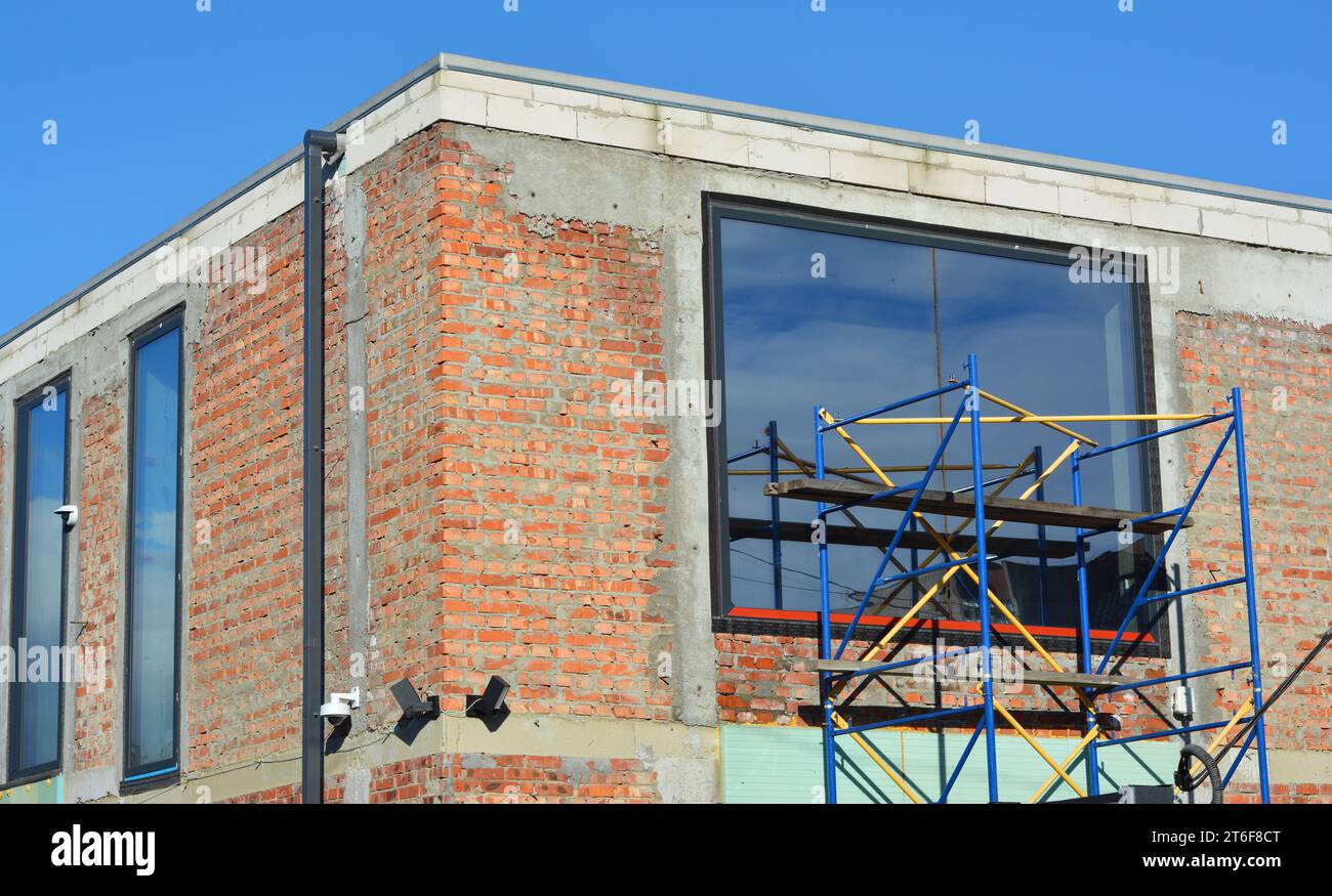 Modern brick house under conctruction with flat roof, panoramic windows ...