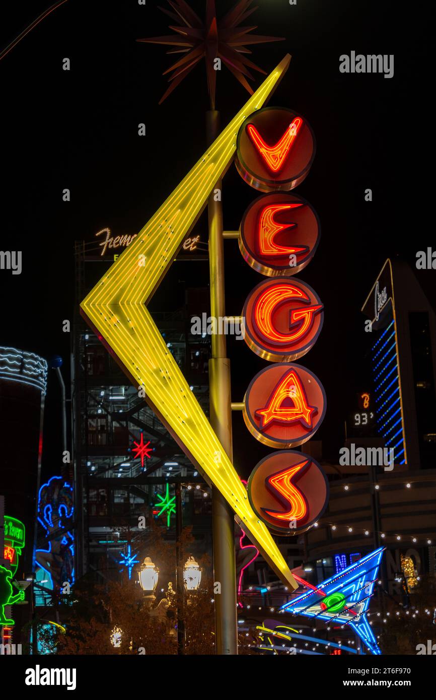 A vibrant nighttime cityscape featuring a bustling street lined with ...