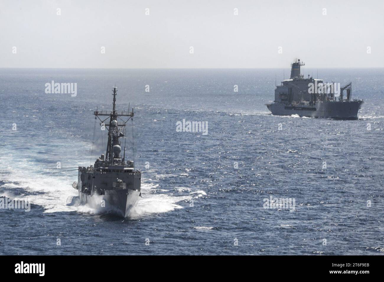 USS Rodney M. Davis moves off after a replenishment-at-sea with USNS ...