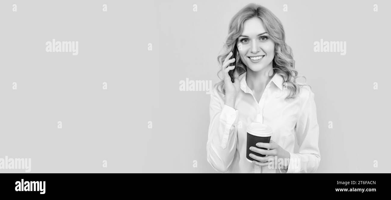 happy blonde woman with coffee cup talking on phone on yellow ...