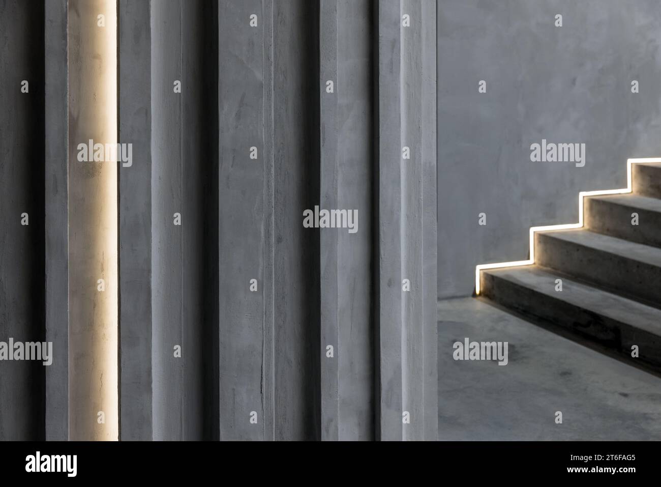 Abstract dark concrete room interior background. Wall and stairs with ...