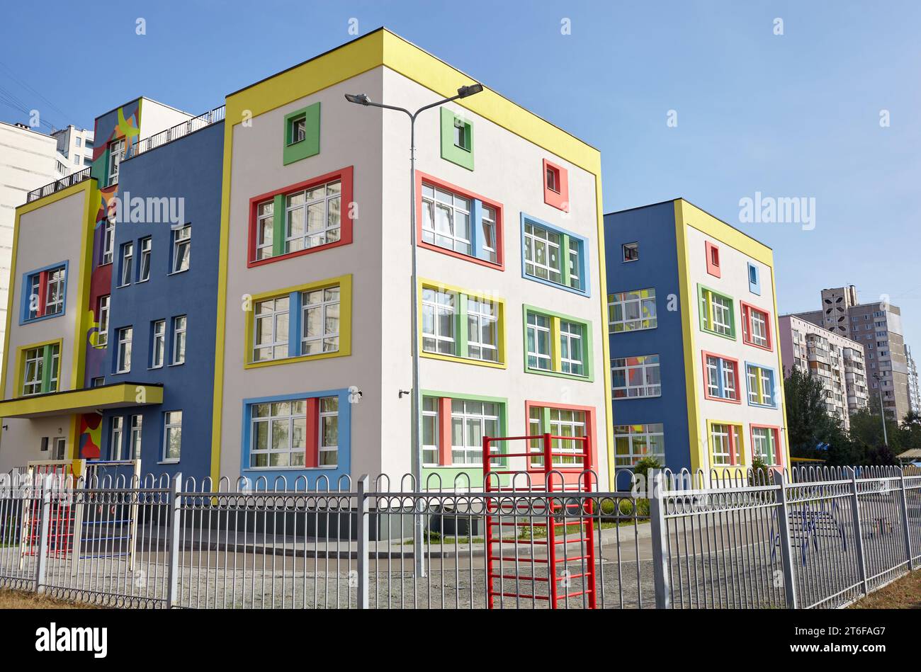 Facade of kindergarten building. Colorful playground for childrens on a ...
