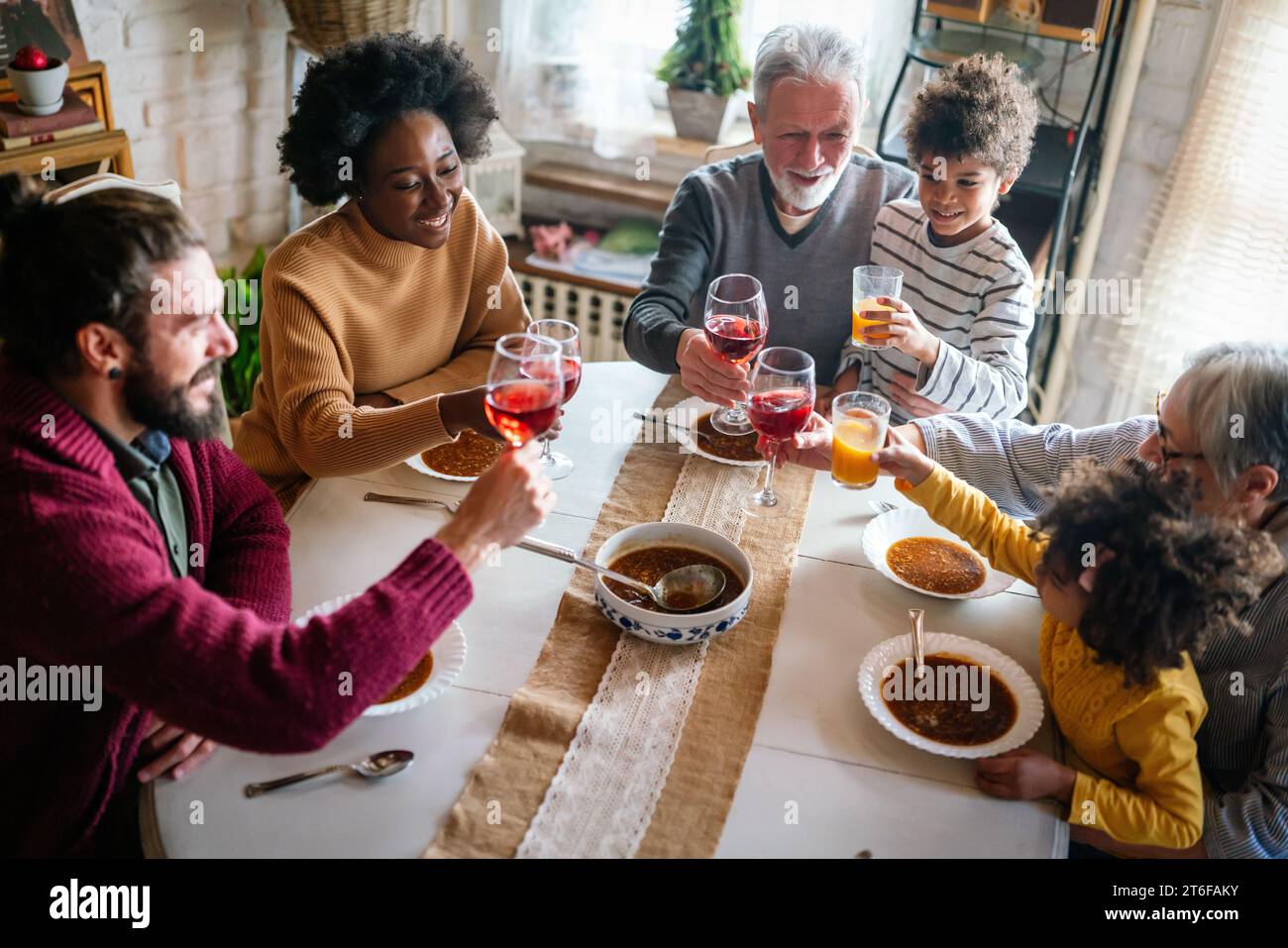Happy multiethnic multigeneration family having fun together around ...